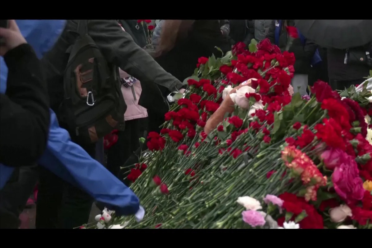 People bring flowers to Crocus City Hall as Russia mourns victims of ...