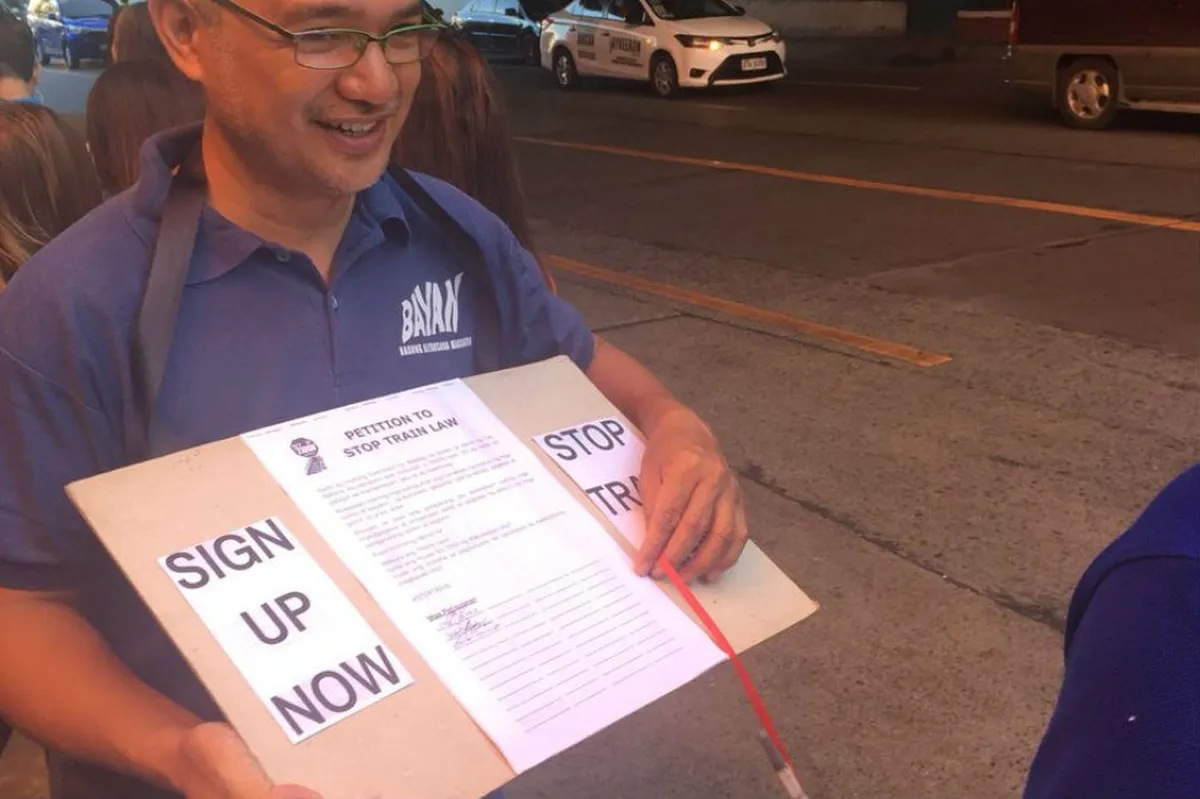 Itigil ang TRAIN! Signature campaign laban sa TRAIN law inilunsad | ABS ...