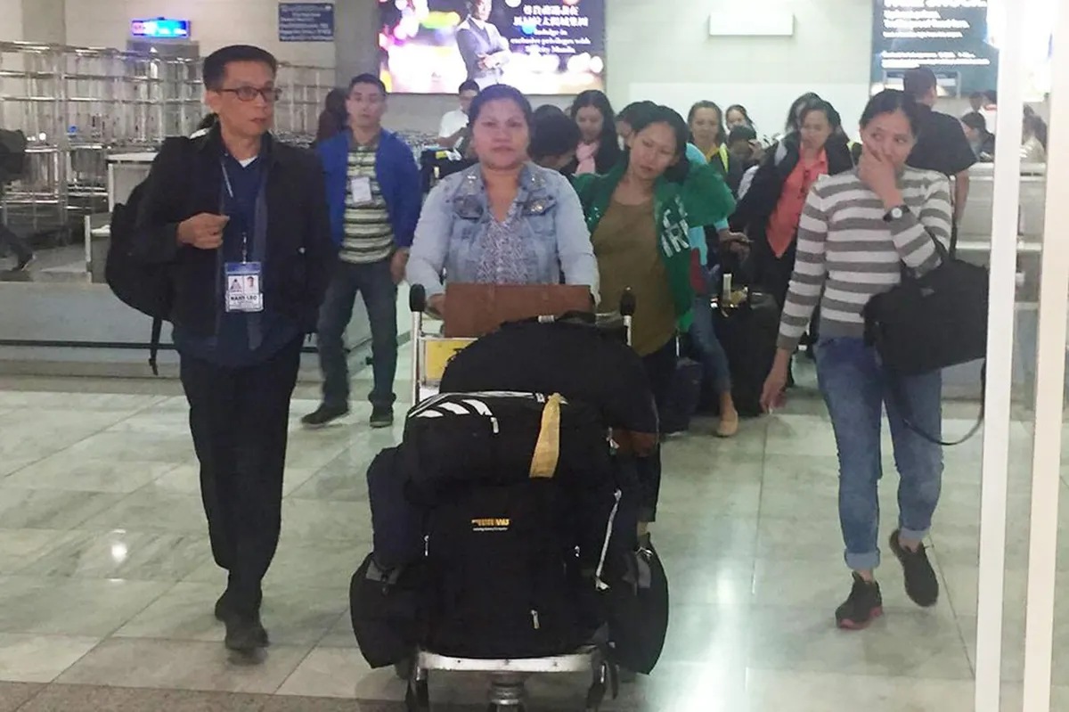 LOOK: 32 distressed OFWs arrive from Kuwait | ABS-CBN News