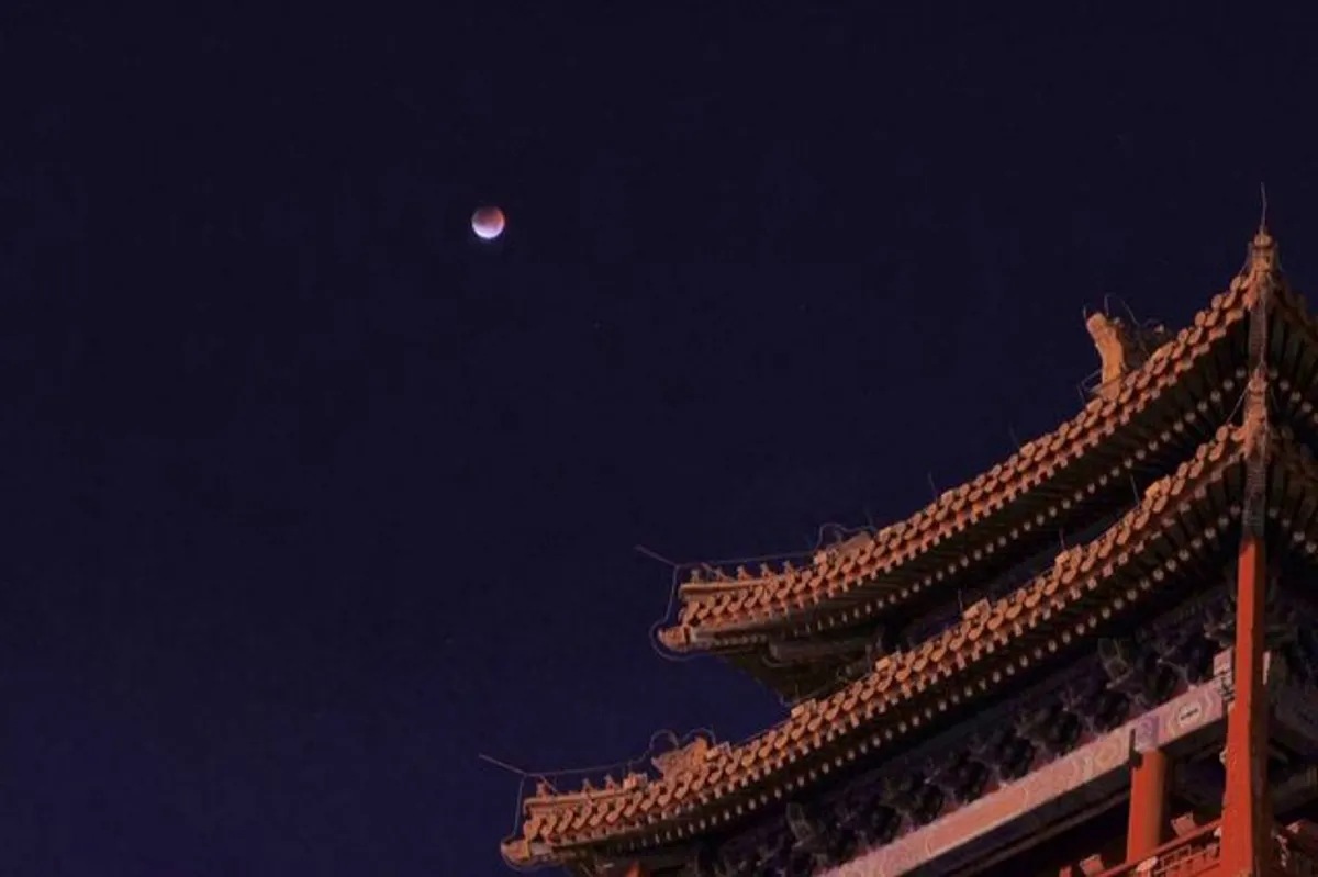 Rare 'Blood Moon' glows over Beijing's Forbidden City during total ...
