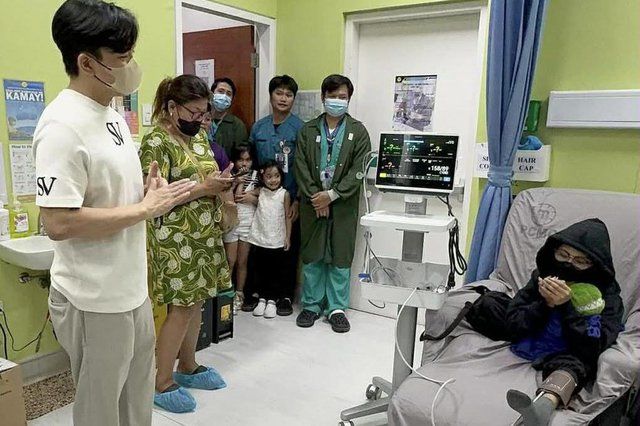 Sam Versoza leads gift-giving activity for children undergoing medical ...