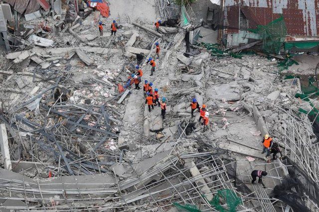 Search teams inch closer to septic tank-turned-barracks in collapsed ...