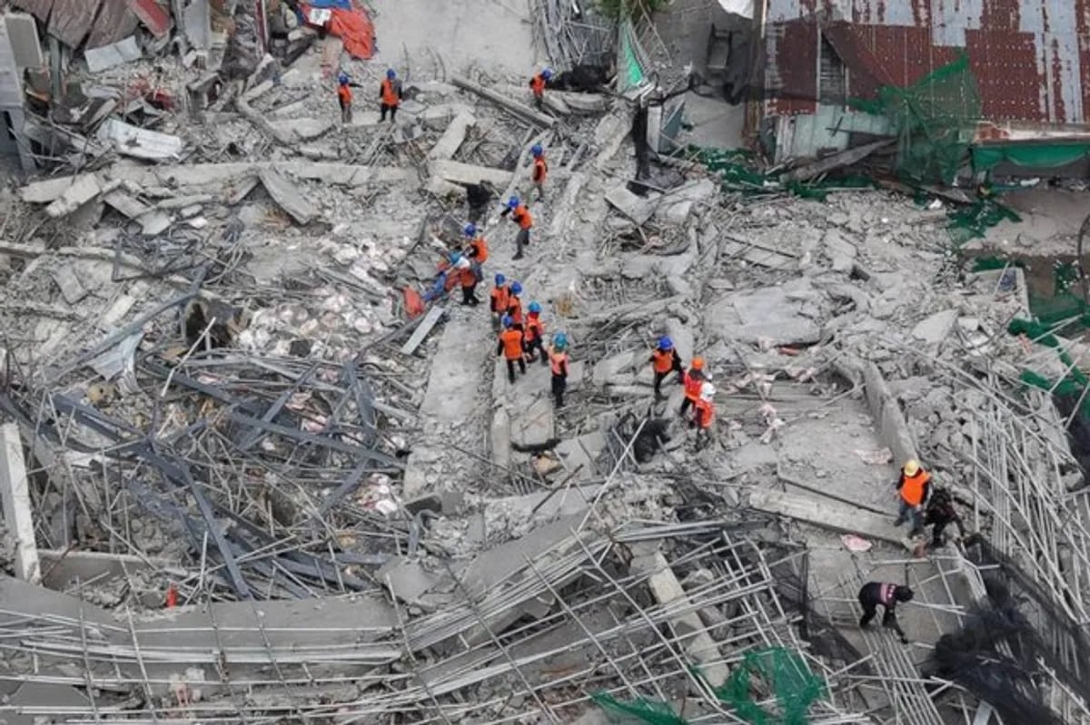 Search teams inch closer to septic tank-turned-barracks in collapsed ...